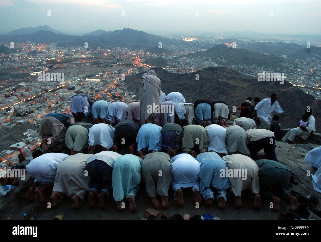 Muslim pilgrims perform sunset prayers at the top of al Nour mountain ...