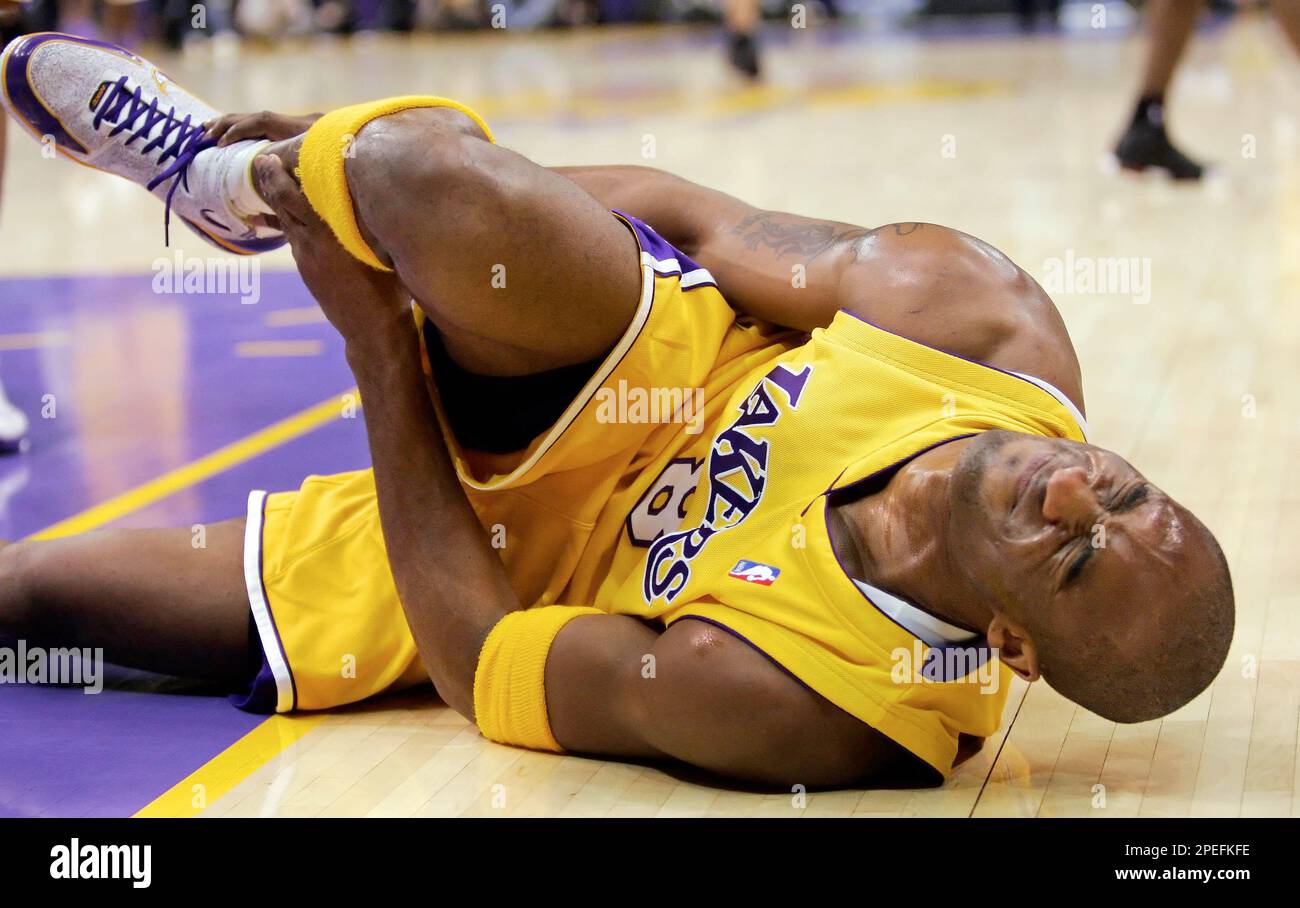 Los Angeles Lakers' Kobe Bryant writhes in pain after injuring his ...