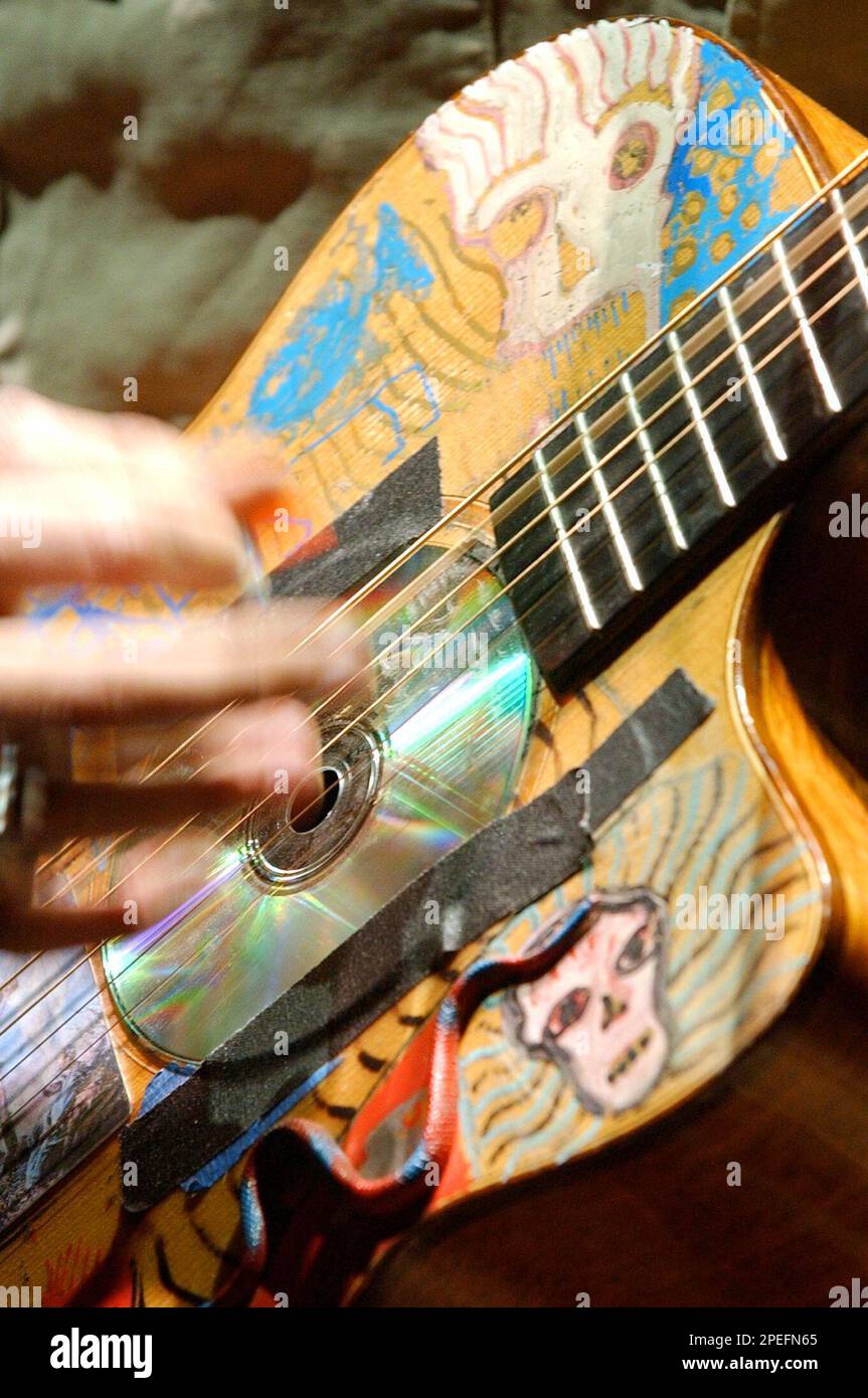 US musician Joseph Arthur plays his painted guitar with a cd taped on ...