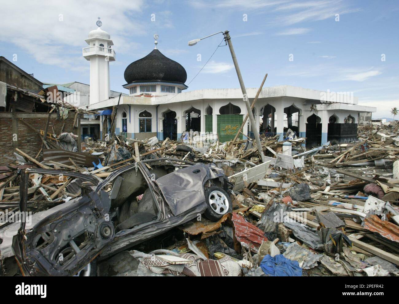 Debris are scattered around a standing mosque at Banda Aceh, the ...