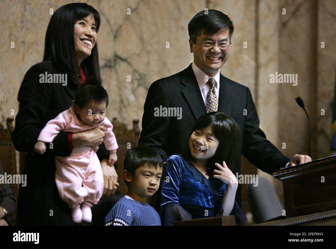 Gov. Gary Locke, right, smiles as he stands with his family during his ...