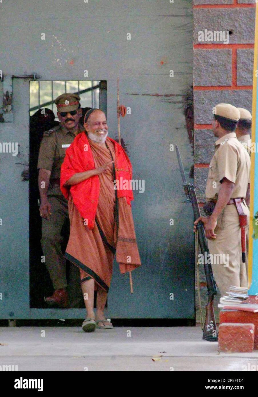Revered Hindu cleric Jayendra Saraswathi gestures to policemen as he ...