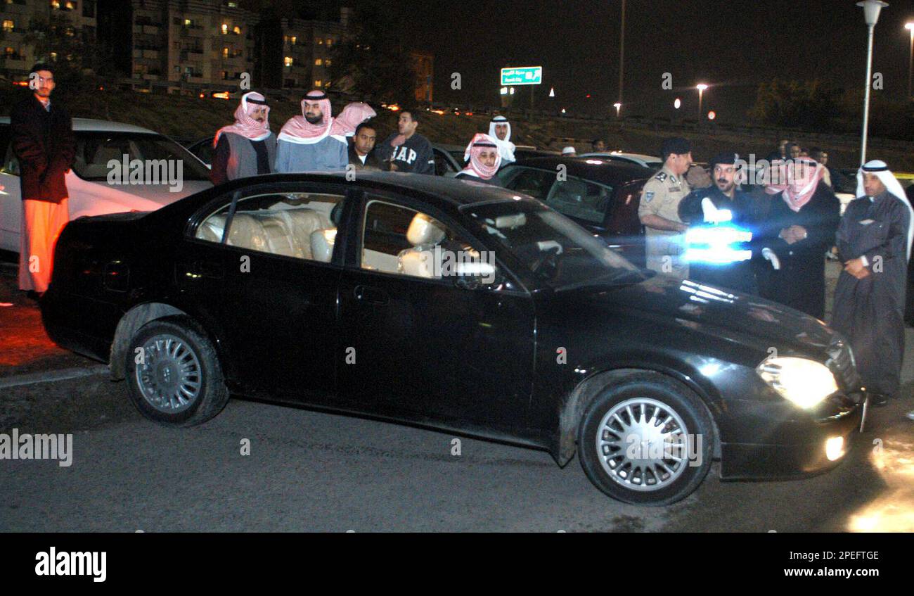 Kuwait's police personnel inspect the vehicle used by the alleged ...