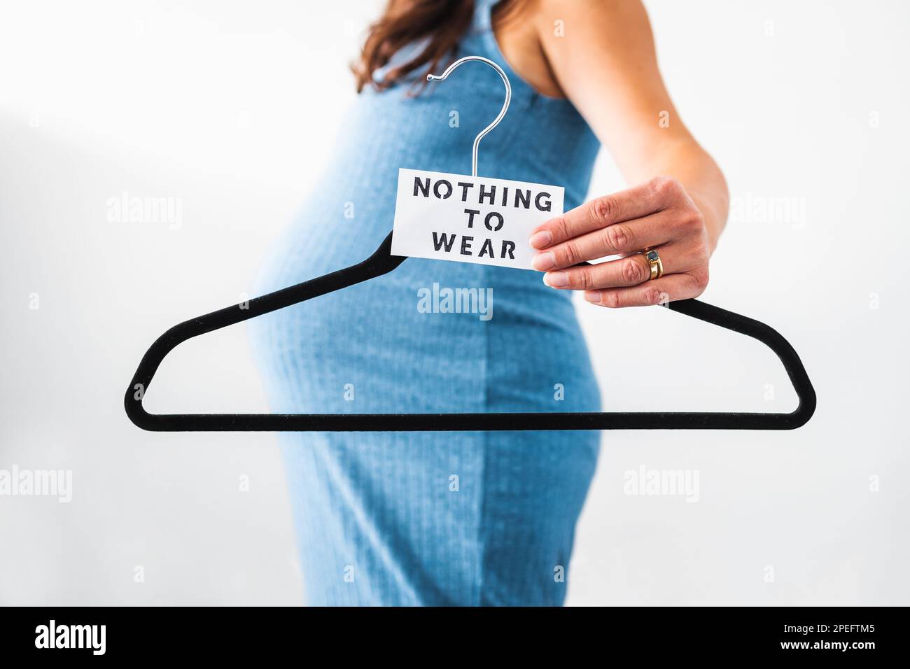Nothing to Wear sign held by pregnant woman in the last month of ...