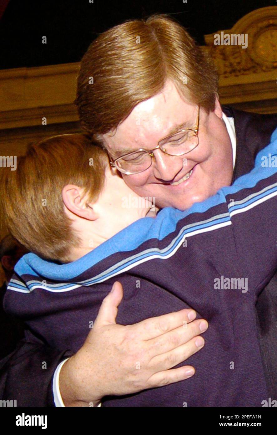 Supreme Court Justice Brent Benjamin, right, gets a hug from his son ...