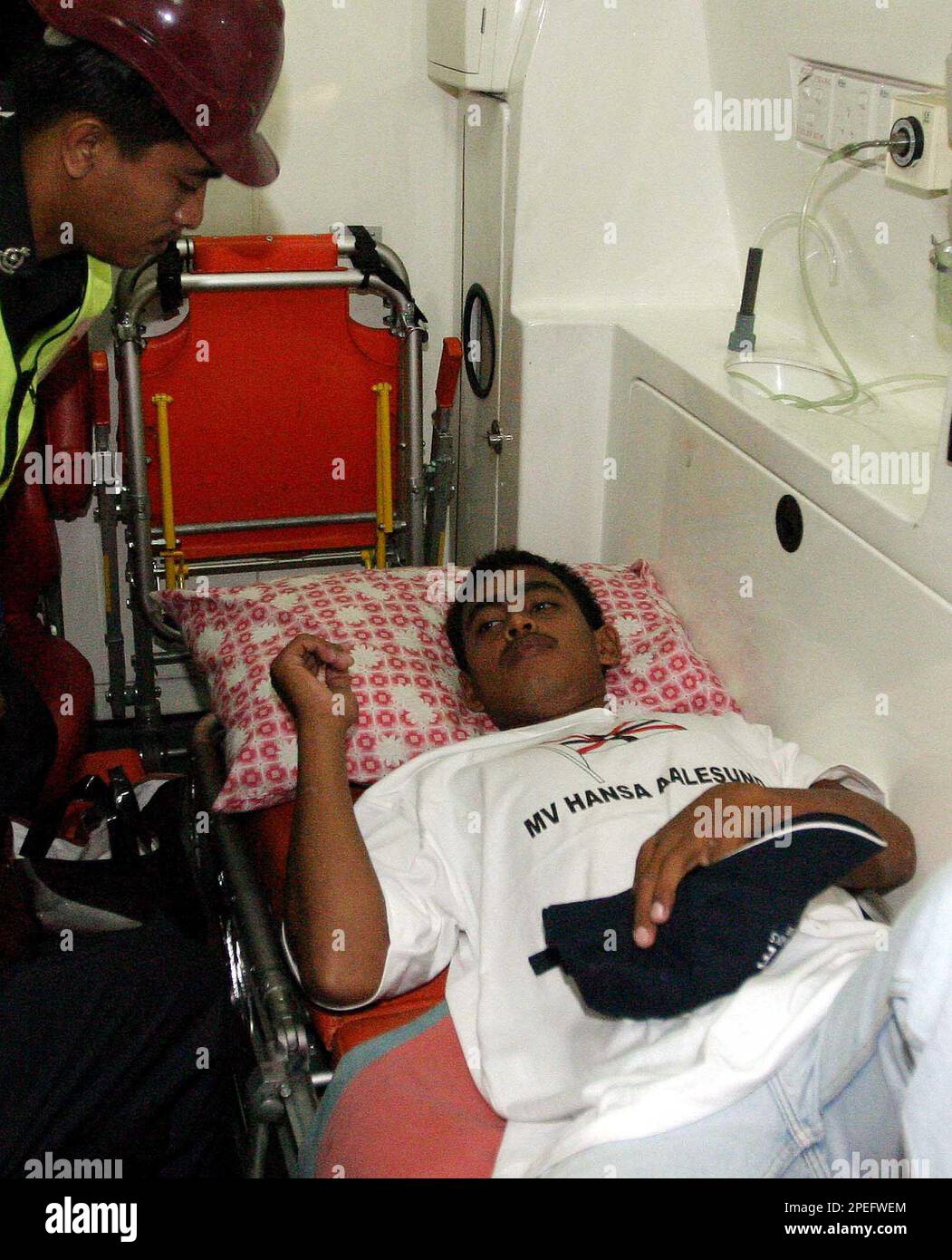 Tsunami survivor Indonesian Ari Afrizal rests inside an ambulance ...