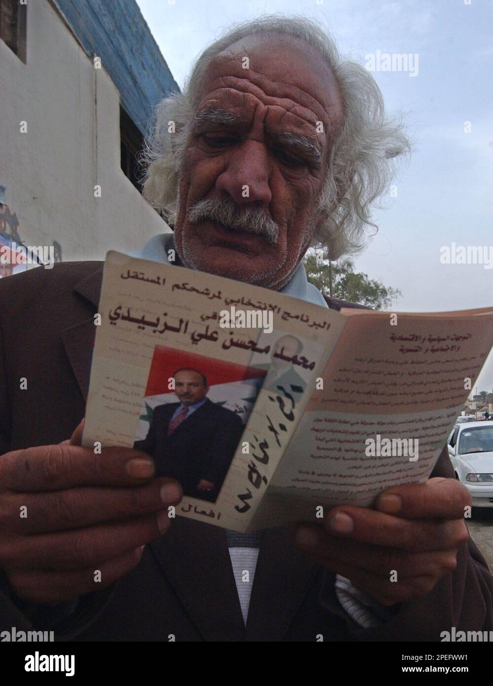 An Iraqi man reads an election leaflet in Baghdad's downtown, Monday ...