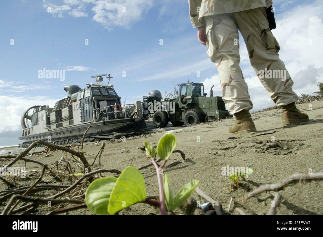 A forklift disembarks from a Landing Craft, Air Cushion (LCAC), a flat ...