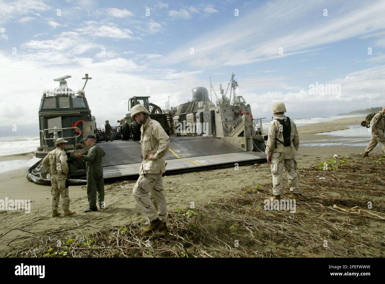 U.S. Marines are seen standing in front of a Landing Craft, Air Cushion ...