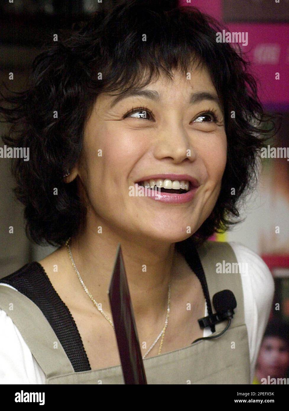 Taiwanese actress Sylvia Chang poses with a knife at a Hong Kong store ...