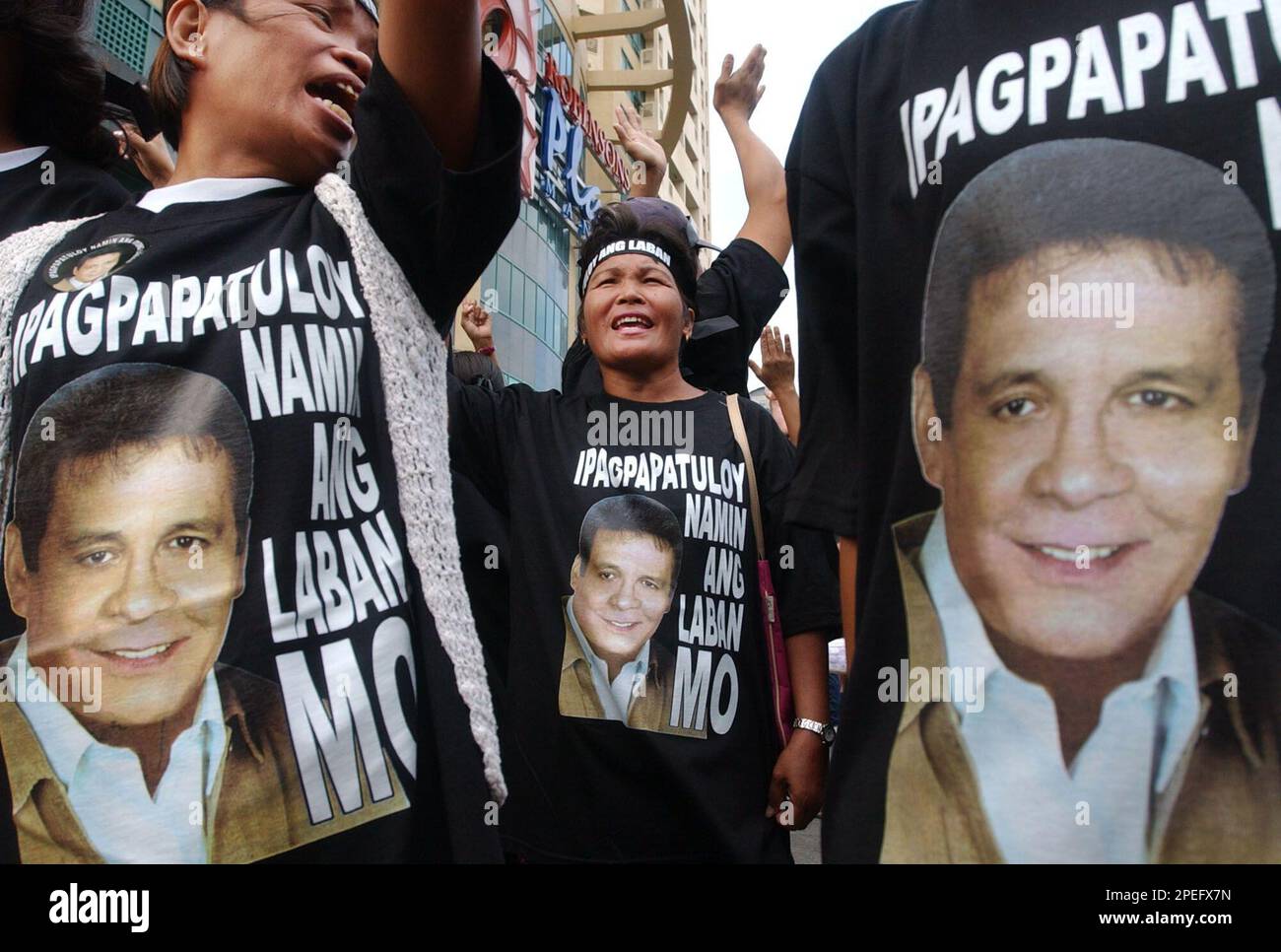 Supporters wearing a shirt with the portrait of the late former presidential candidate Fernando ...