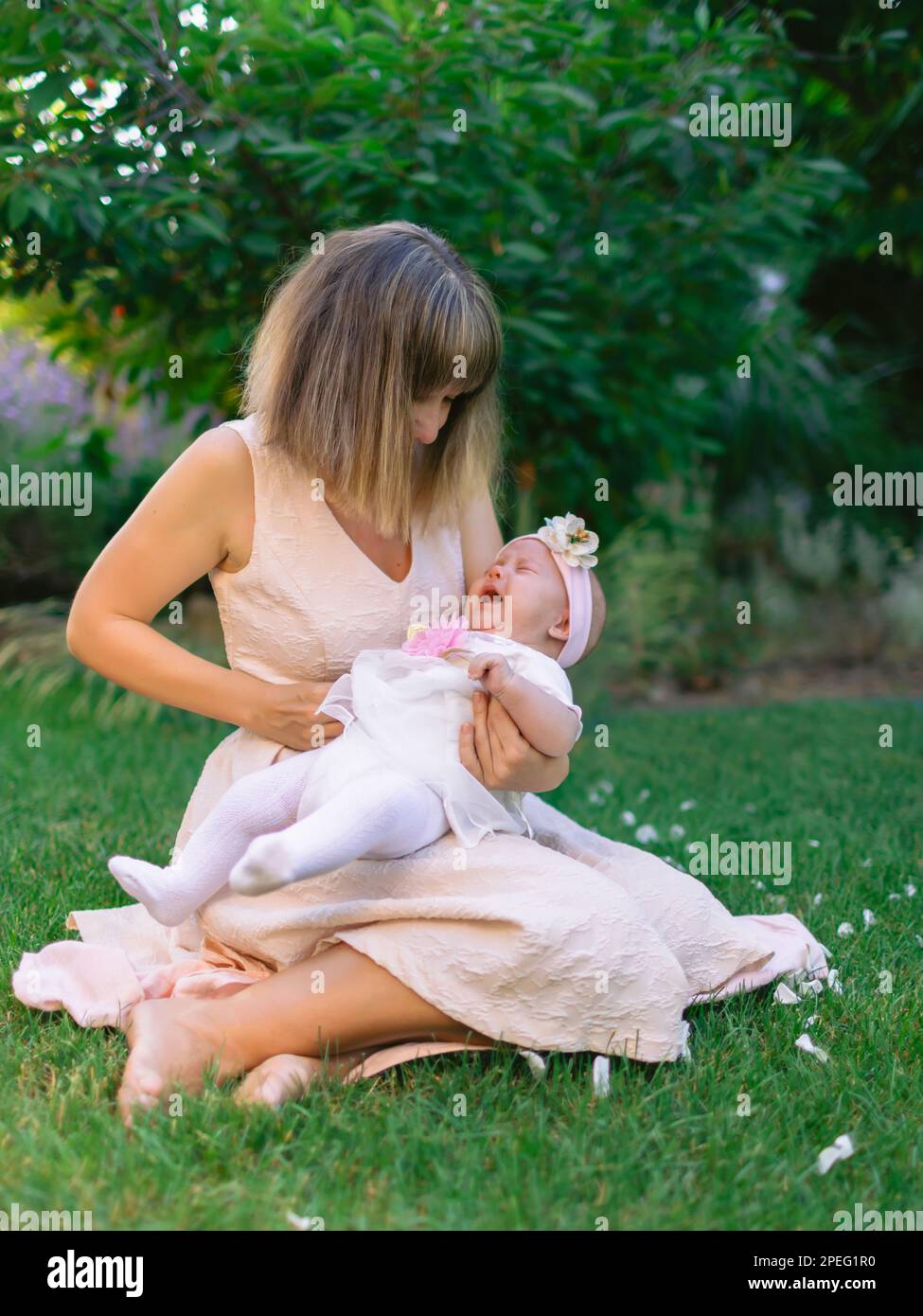Mother with her crying baby in outdoor backyard garden Stock Photo - Alamy
