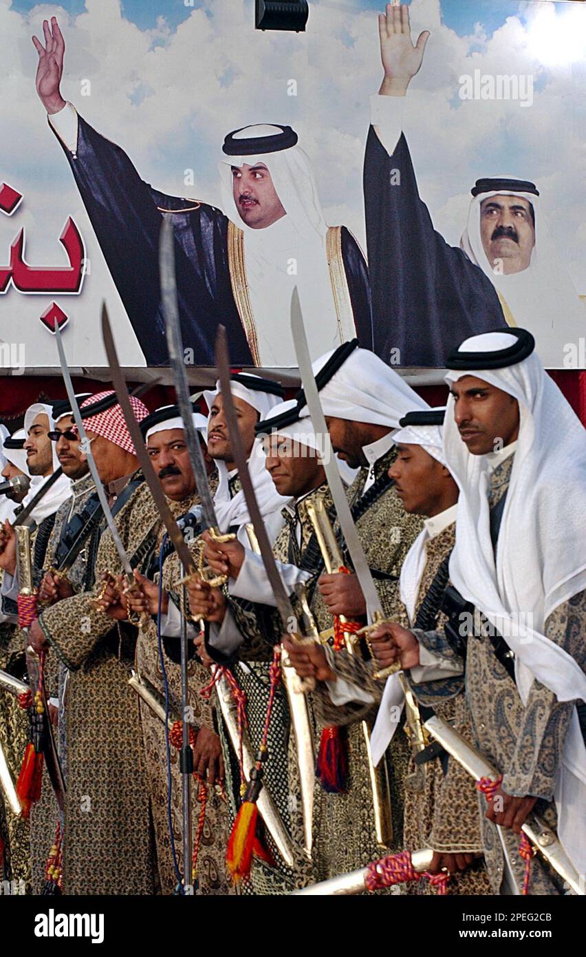 Qatari men from the Bani Yafe tribe perform a traditional dance as they ...