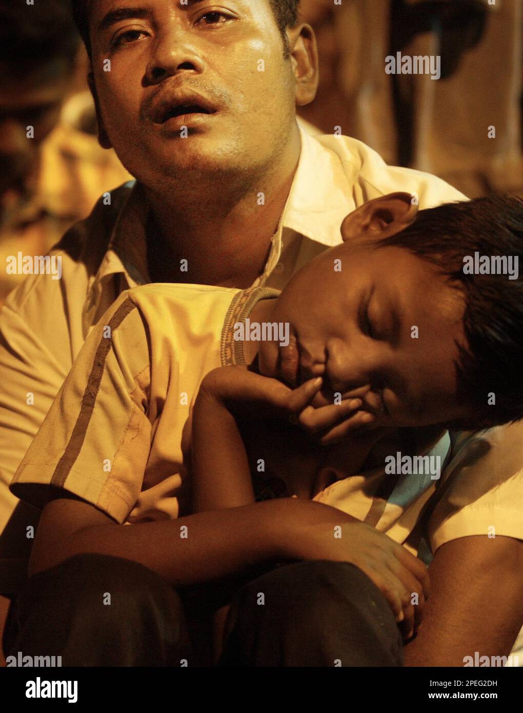 A tsunami affected Nicobari tribal man from Car Nicobar, with his son ...