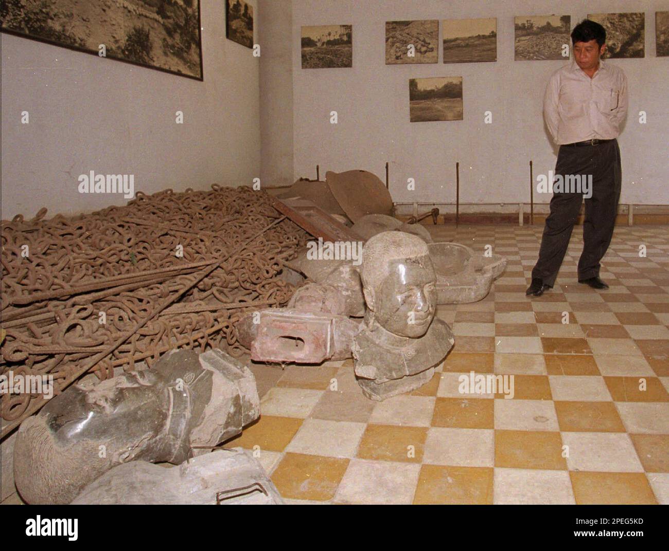 A visitor to Toul Sleng, officially known as S-21, looks at broken ...