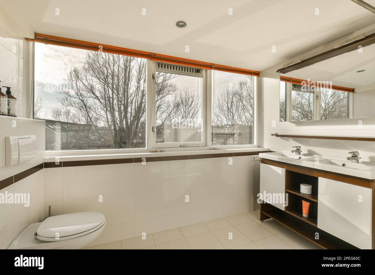 a bathroom with a toilet, sink and window overlooking the ...
