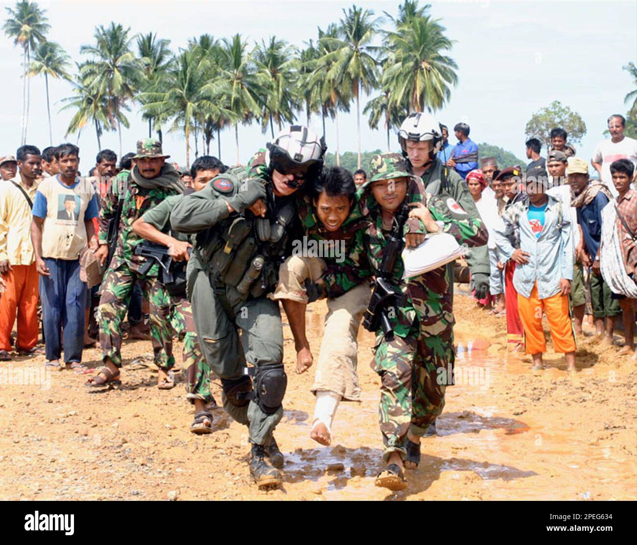 An injured tsunami survivor is evacuated by military personnel ...