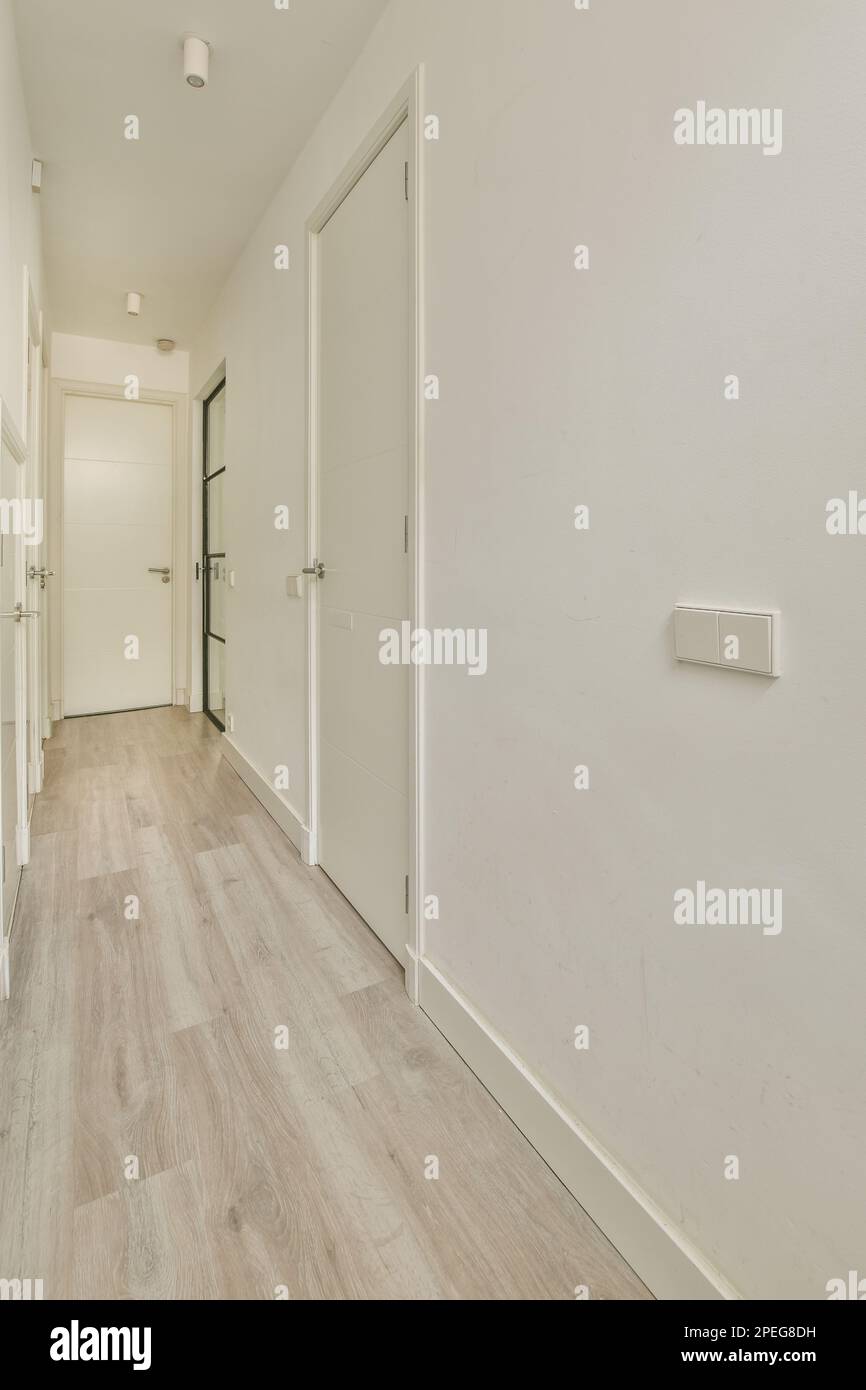 an empty room with white walls and wood flooring on the left side of ...