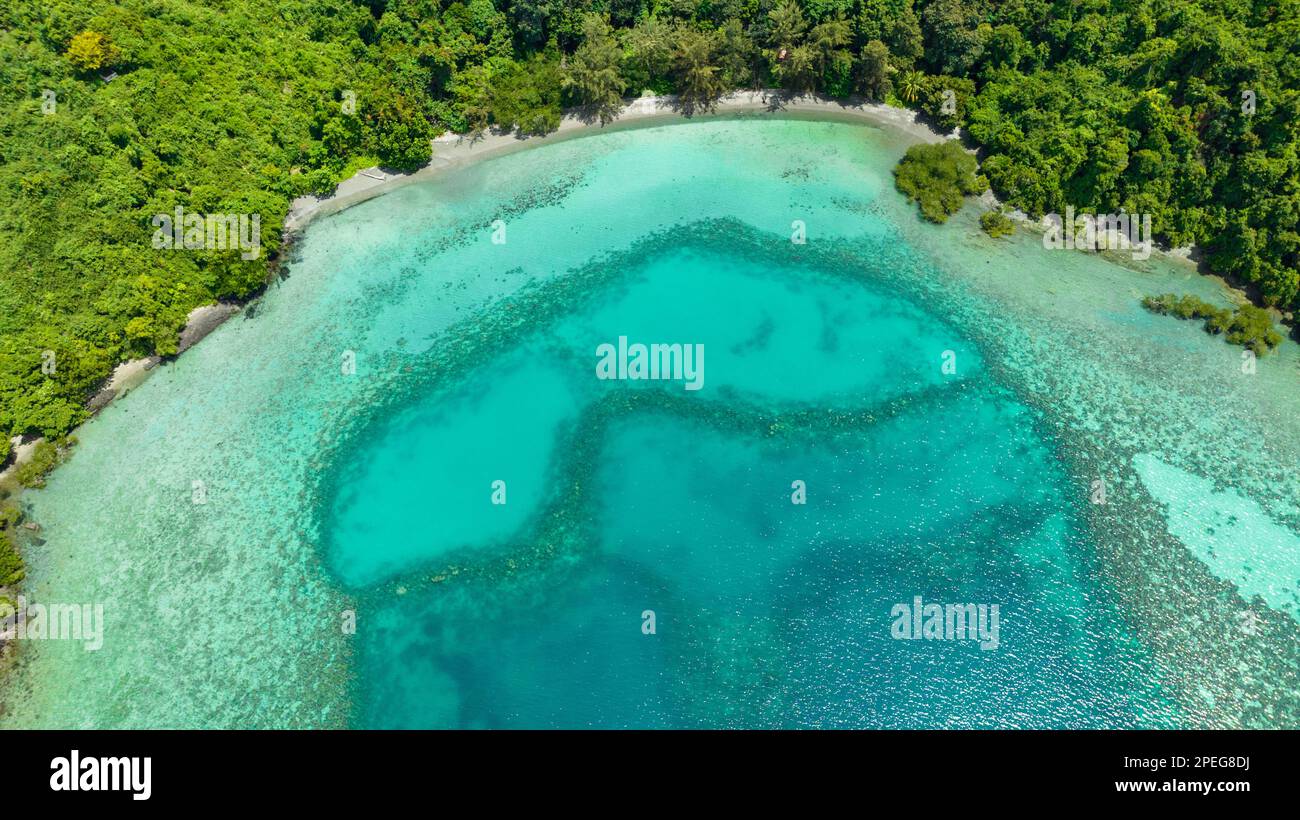Aerial drone of lagoon with turquoise water in the bay of a tropical ...