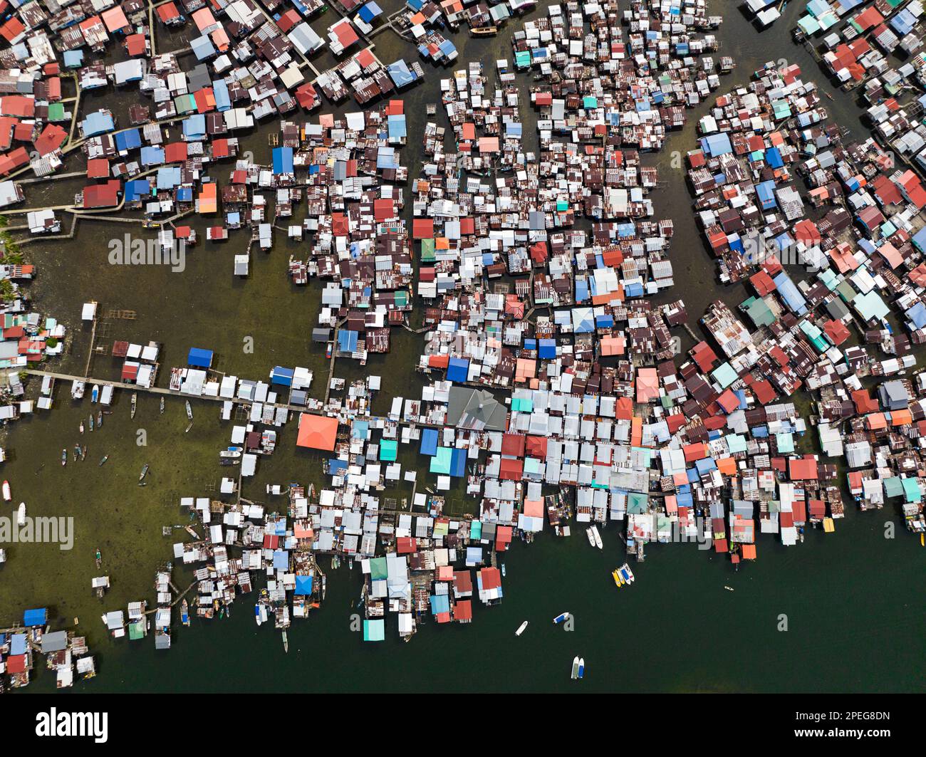 A village in Borneo with houses standing in the water on stilts view ...