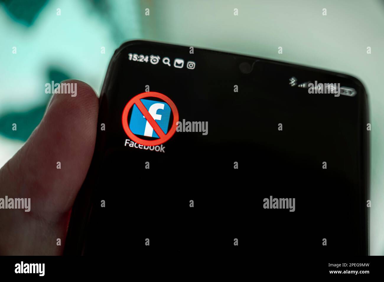 A crossed-out icon on a black smartphone screen. the concept of banning ...