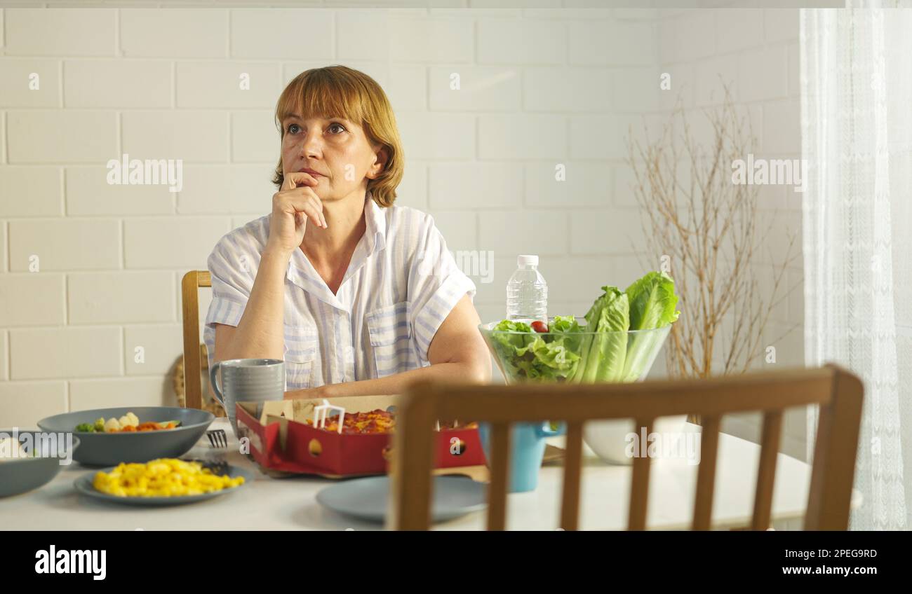 Elderly retired grandmother stay at home with unhappy face sitting ...