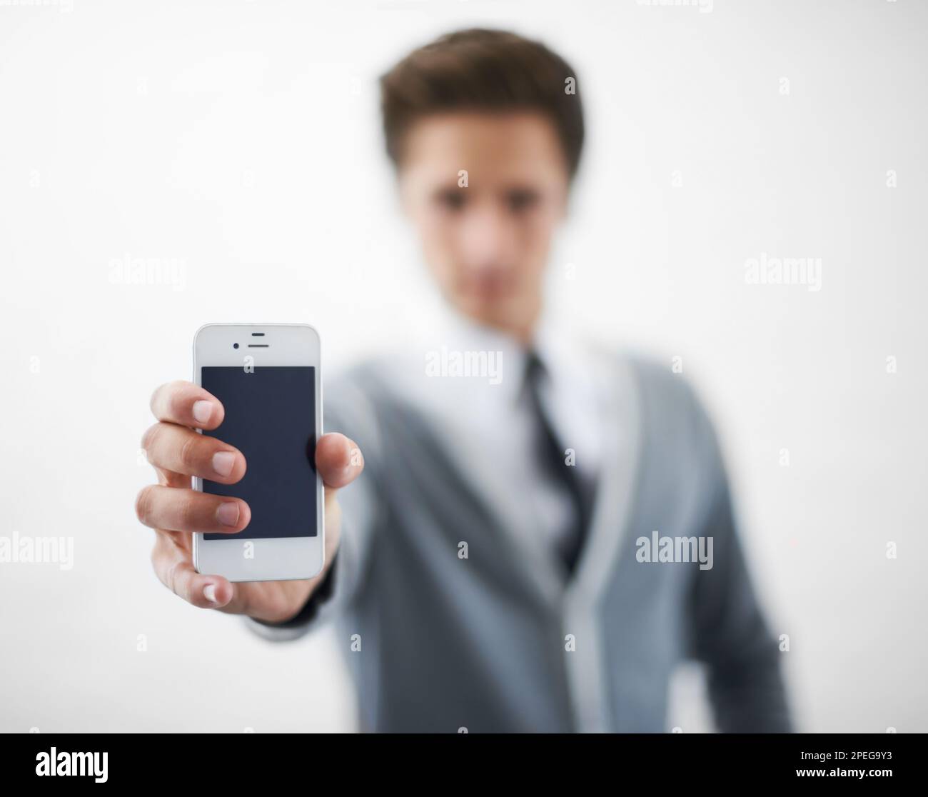 Presenting the newest smartphone. A young man holding his smartphone ...