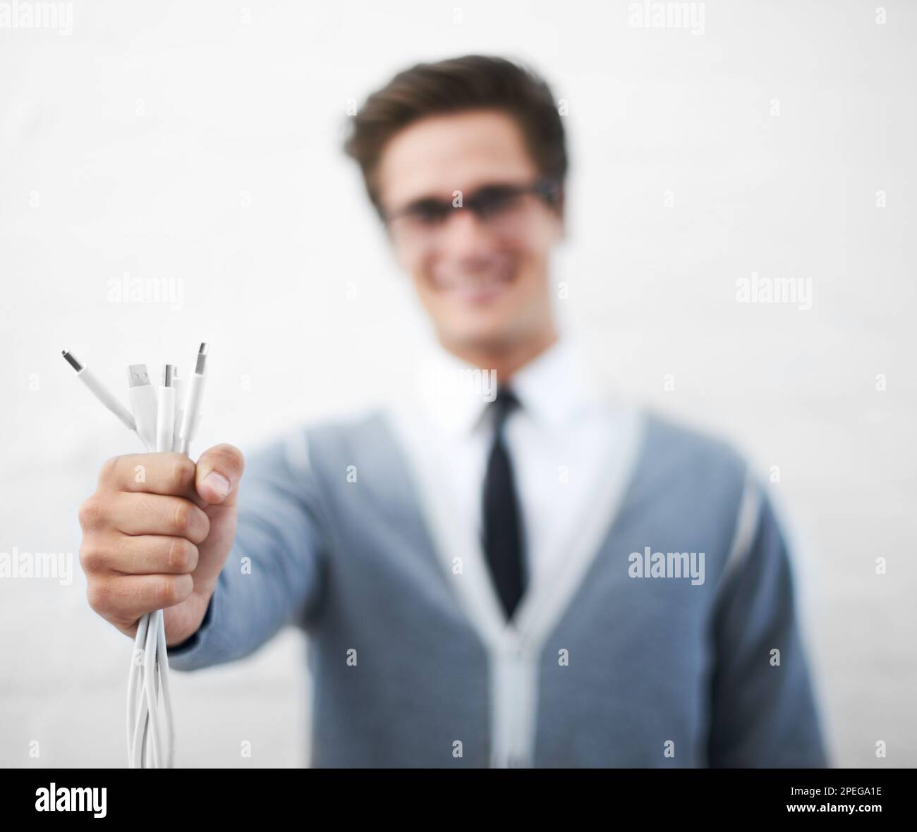 Cables are his kind of thing. A young nerdy guy holding usb cables ...