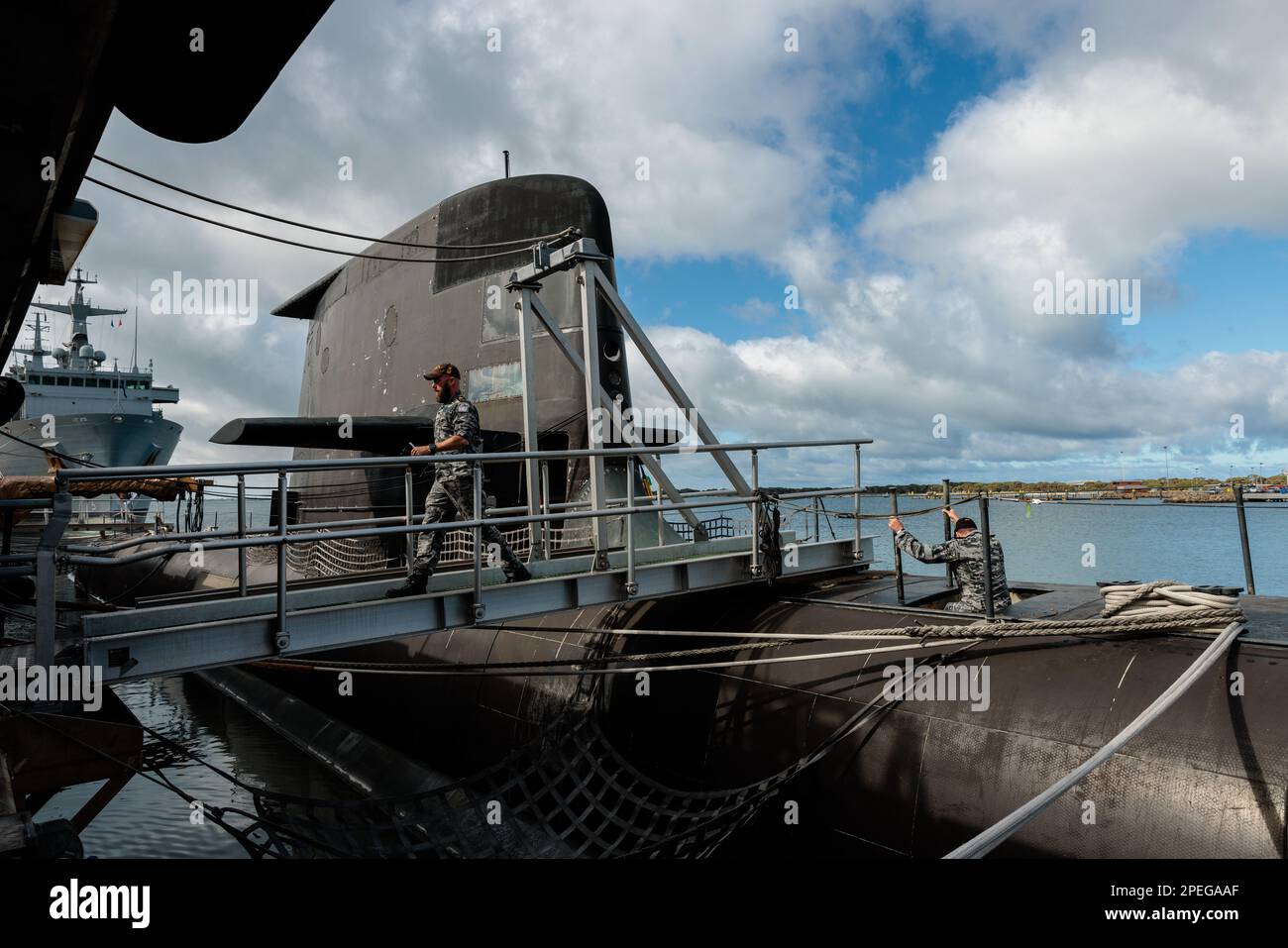 Crew members are seen working onboard HMAS Rankin, a Collins Class ...