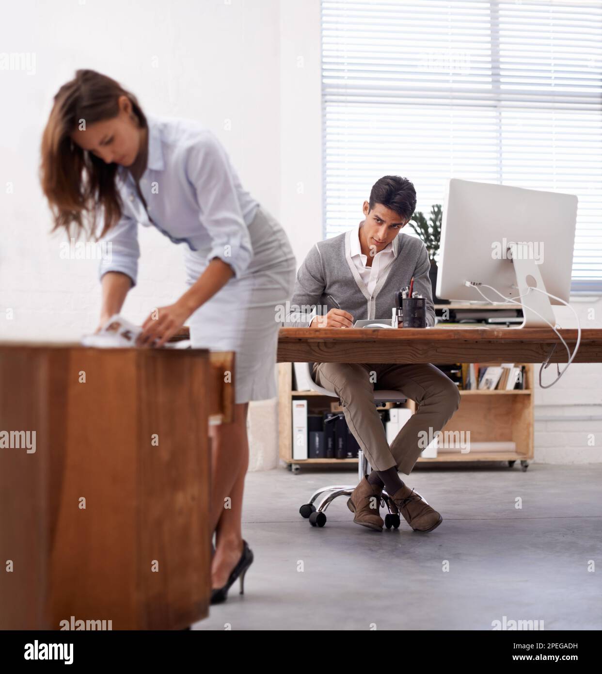 Unsuitable behaviour for the office. A young office worker looking up ...