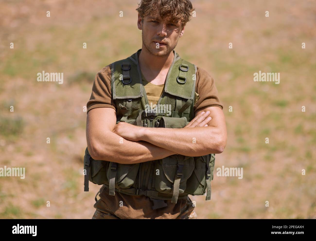 Confident in his abilities. A handsome soldier looking at the camera ...