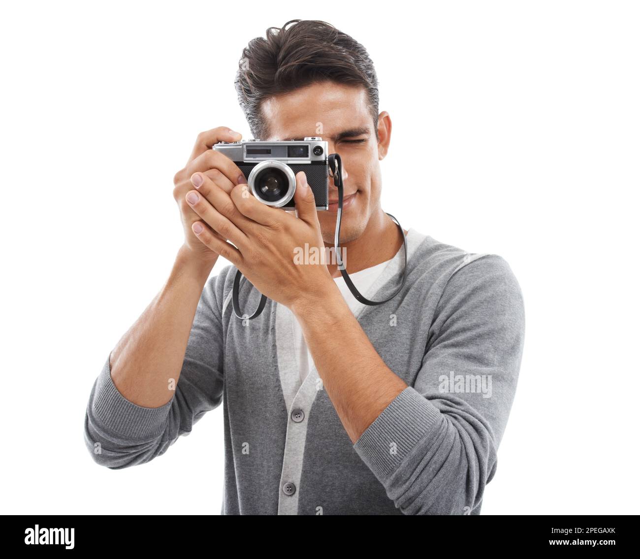 Having fun with his hobby. Portrait of a young man holding a camera and ...