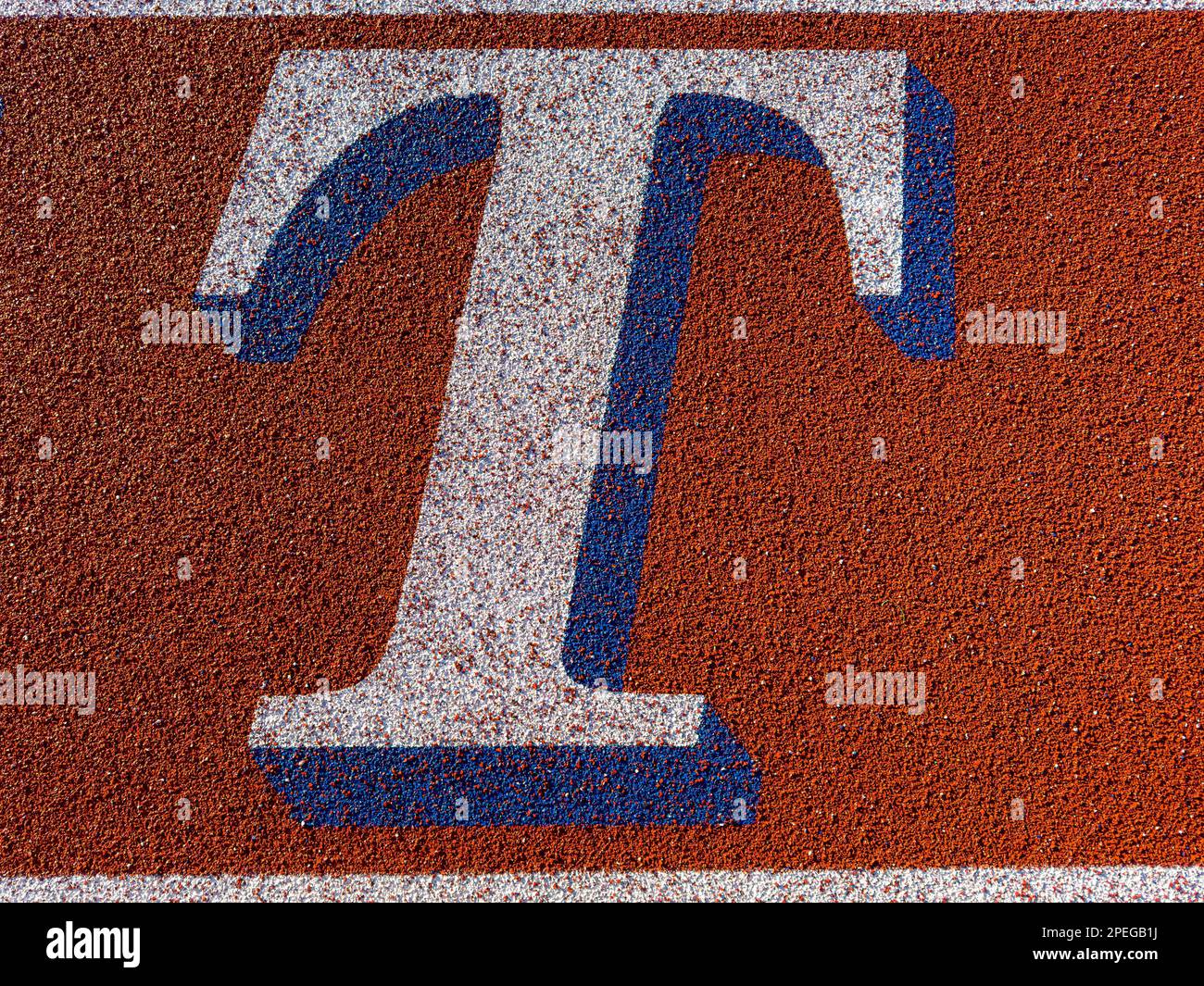 Close up of the letter T on new red running track with white lane lines ...