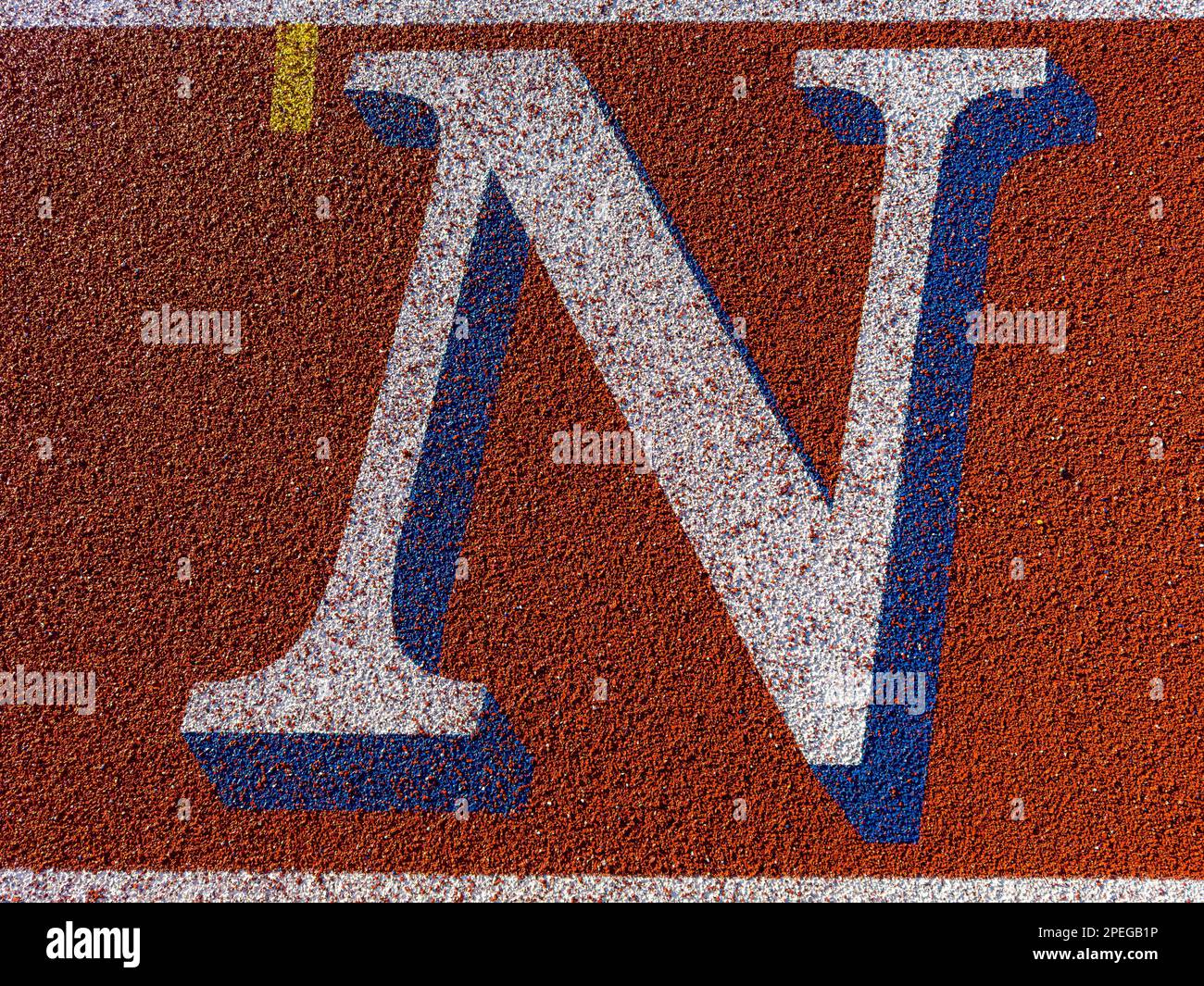 Close up of the letter N on new red running track with white lane lines ...