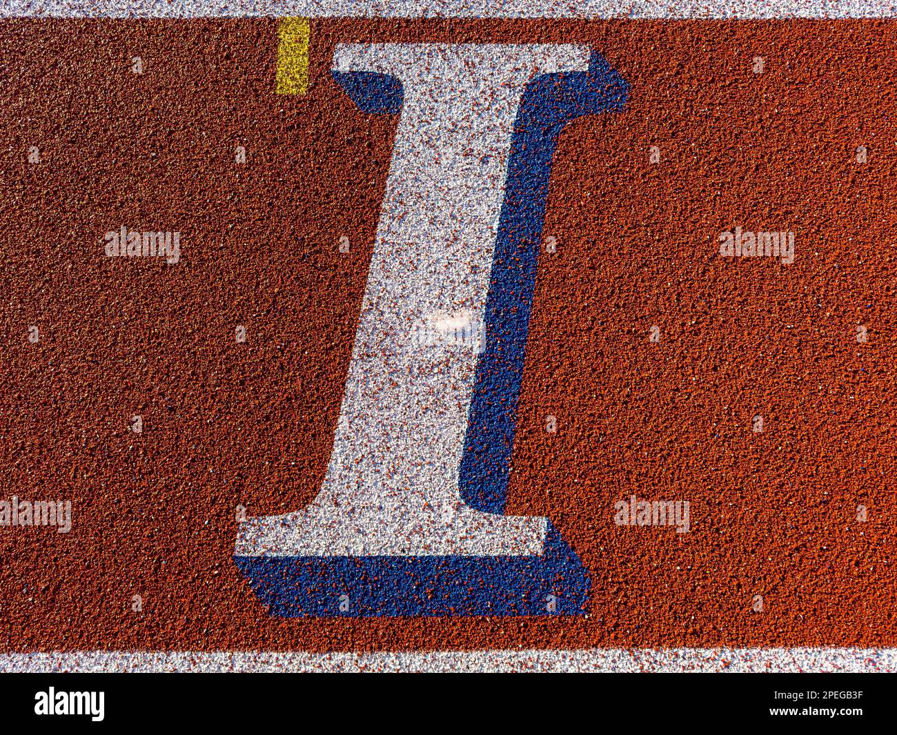Close up of the letter I on new red running track with white lane lines ...