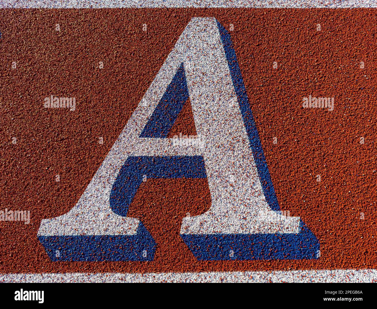 Close up of the letter A on new red running track with white lane lines ...