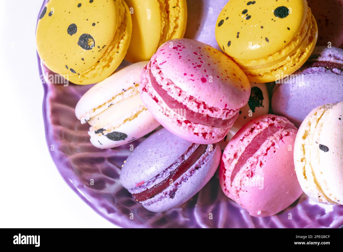 Sweet macaroons macarons in bowl top view. French cookies with vanilla ...