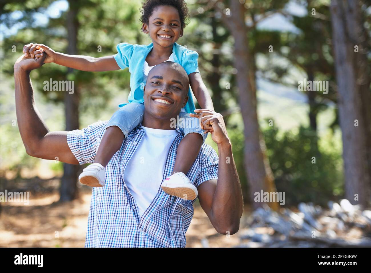 Teaching his little girl about nature. Portrait of a father carrying his daughter on his ...