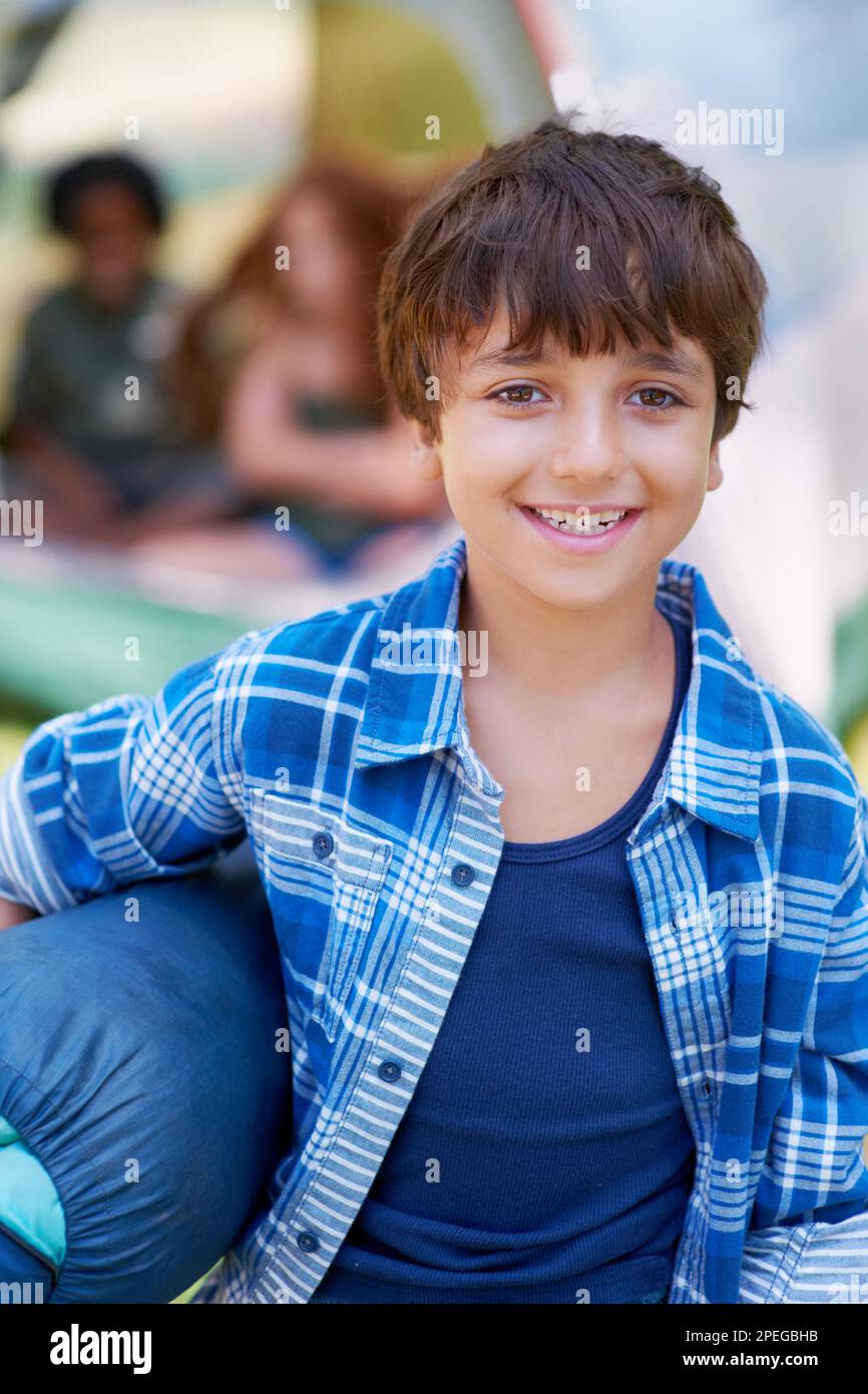 He cant wait for the camp sleepover. A boy standing in front of his ...