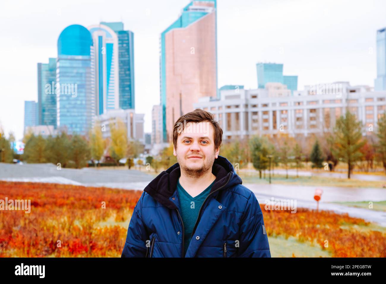 male man portrait on autumn cityscape. looking at camera white european ...