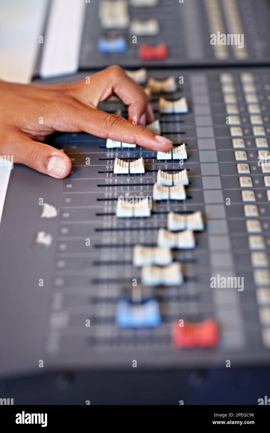 Turn up the tunes. Cropped close-up image of a hand moving a slider on ...