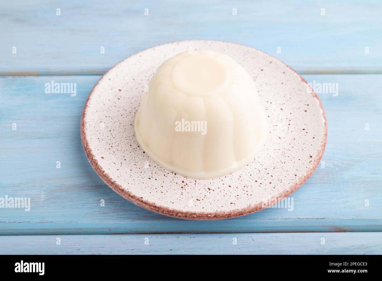 White milk jelly on blue wooden background. side view, close up Stock ...
