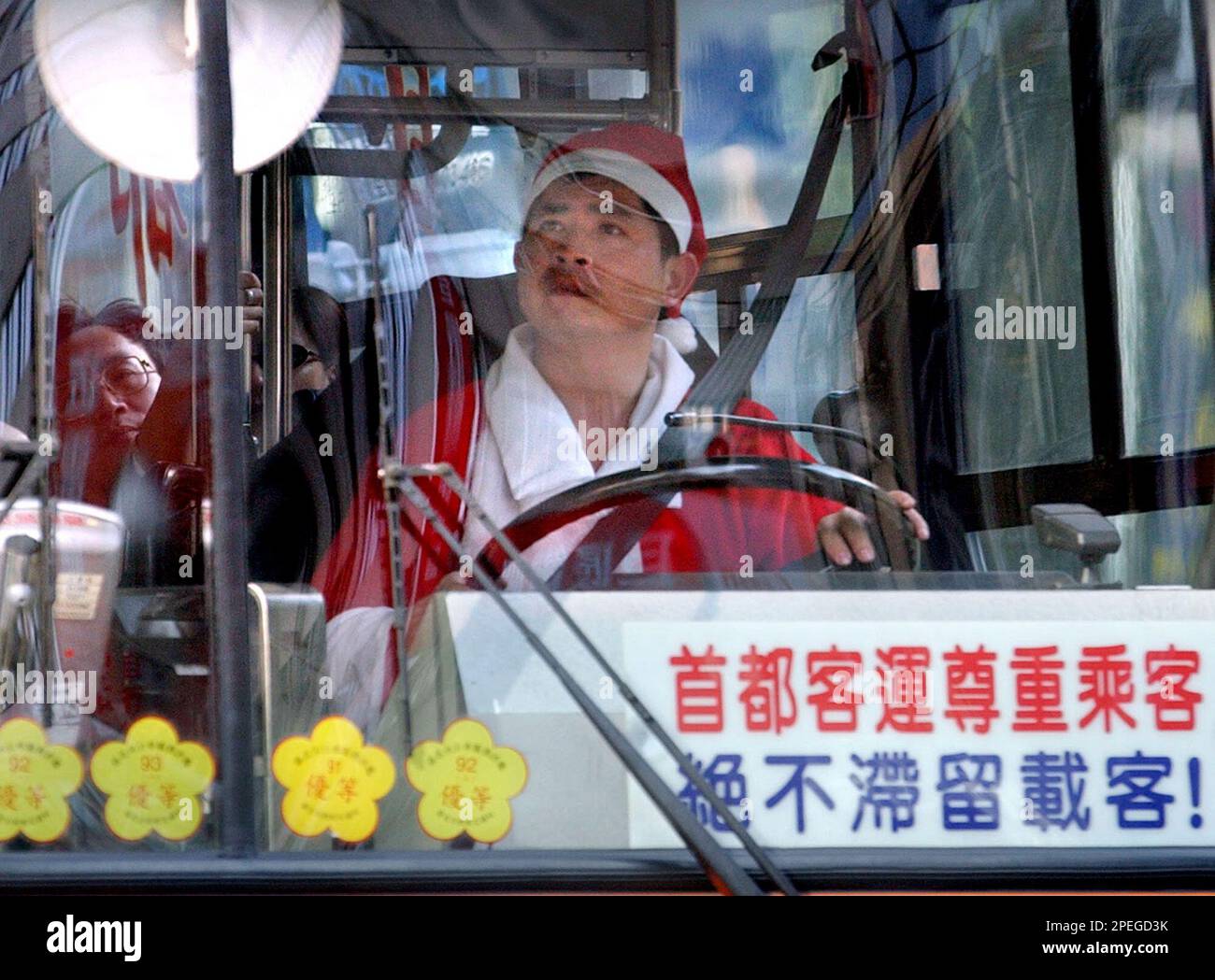A public bus company driver dressed as Santa Claus makes his way ...