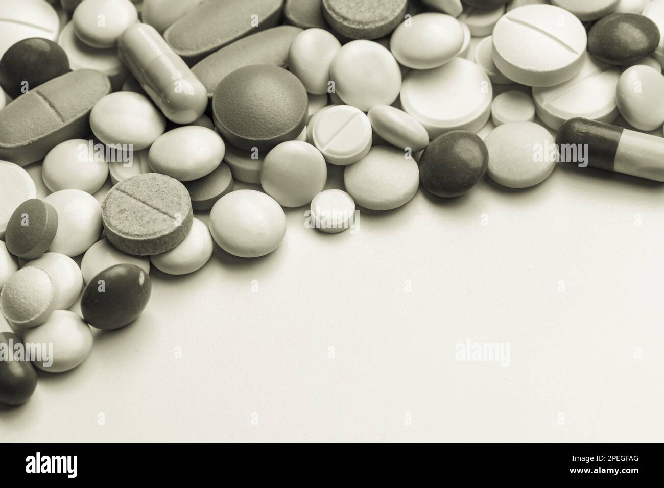 Spilled dark and light harmful pills different size green brown ...