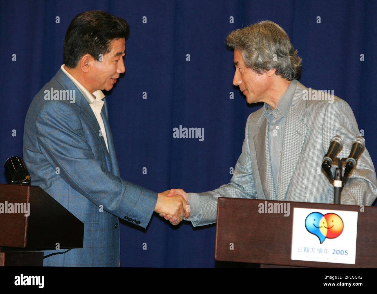 South Korean President Roh Moo-hyun, left, shakes hands with Japanese ...