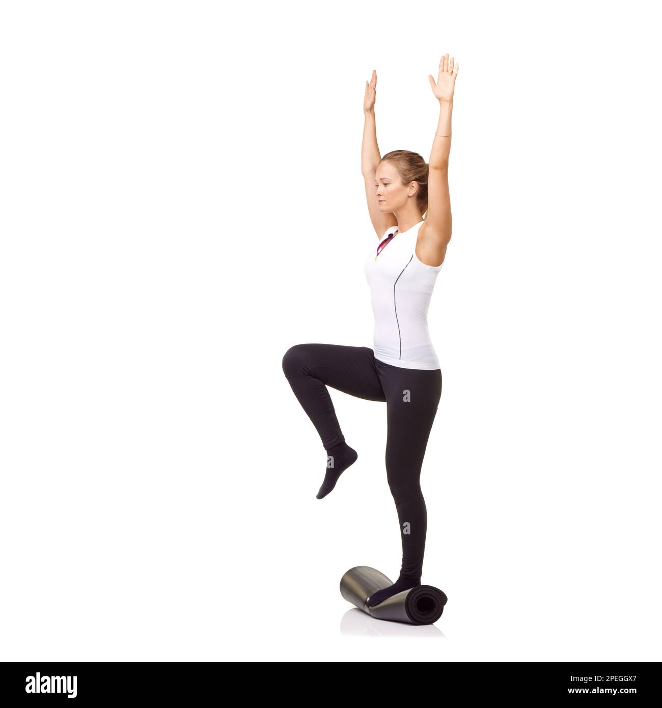 Precise exercise. A pretty young woman balancing on her rolled up ...