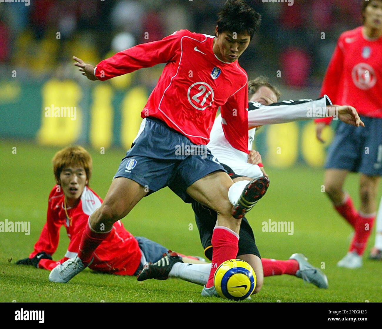 South Korea's Kim Dong-hun (21) struggles with Germany's Arne Friedrich ...