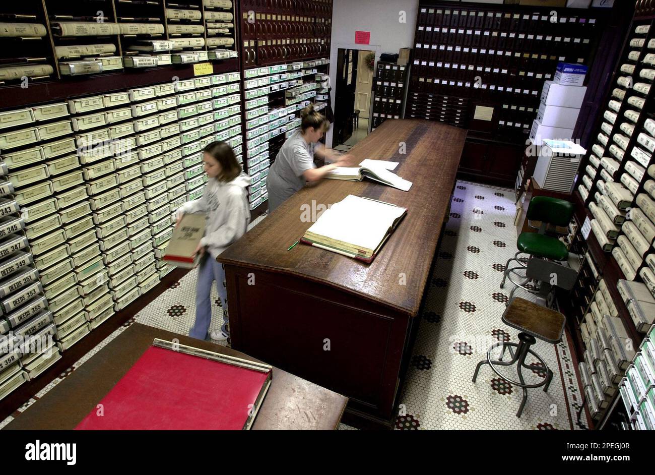 Files are stacked to the ceiling around the walls of the records room ...