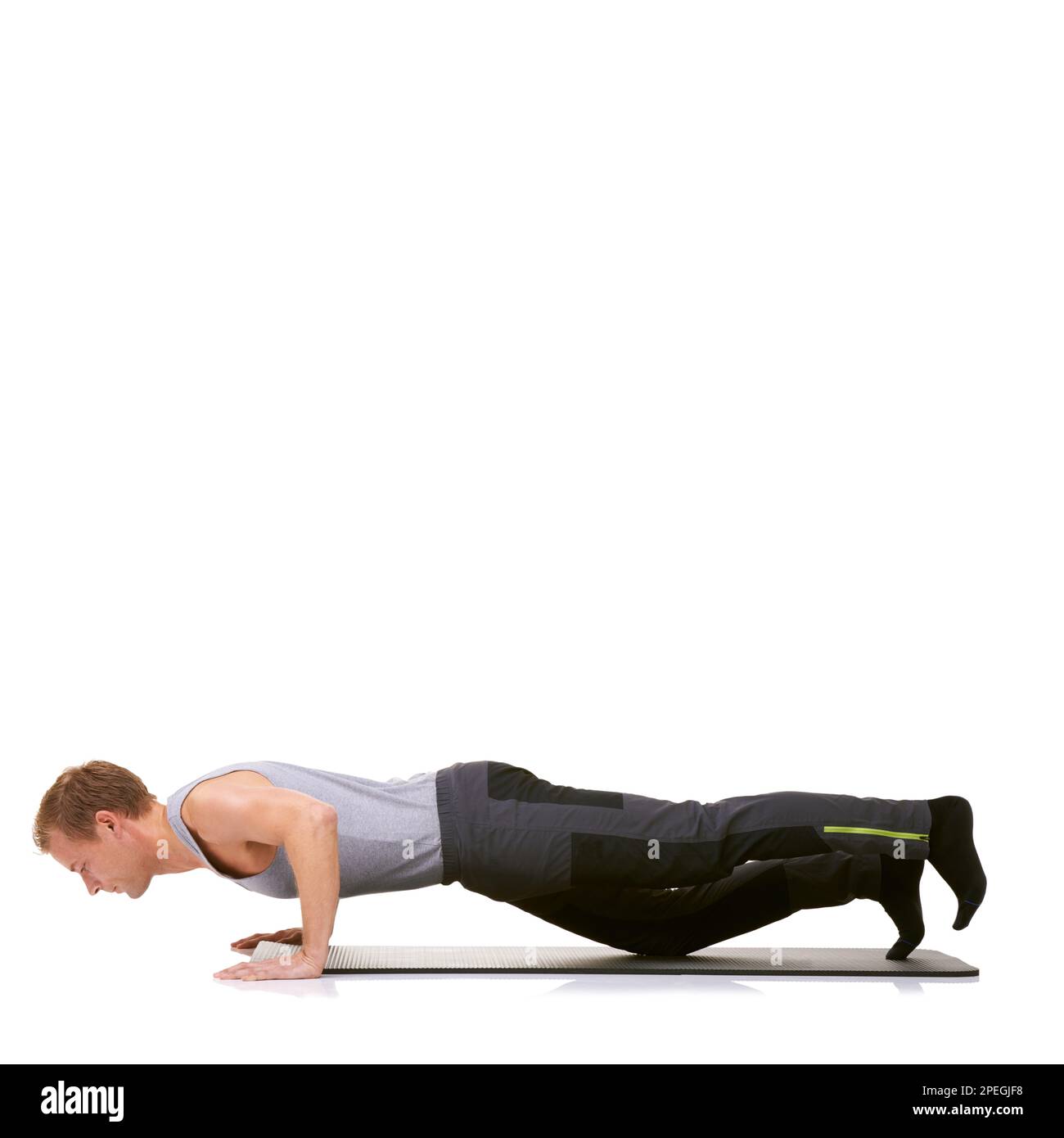 Balance, fitness and dedication. A fit young man working out on his ...