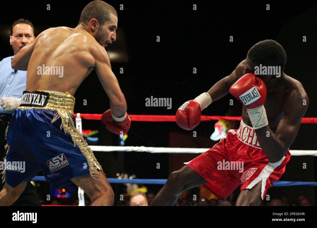 Challenger Vic Darchinyan, left, of Australia lands a punch against ...